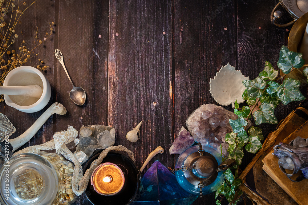 Alchemy lab with mortar and pestle, crystals, snakeskin, potions, oils ...