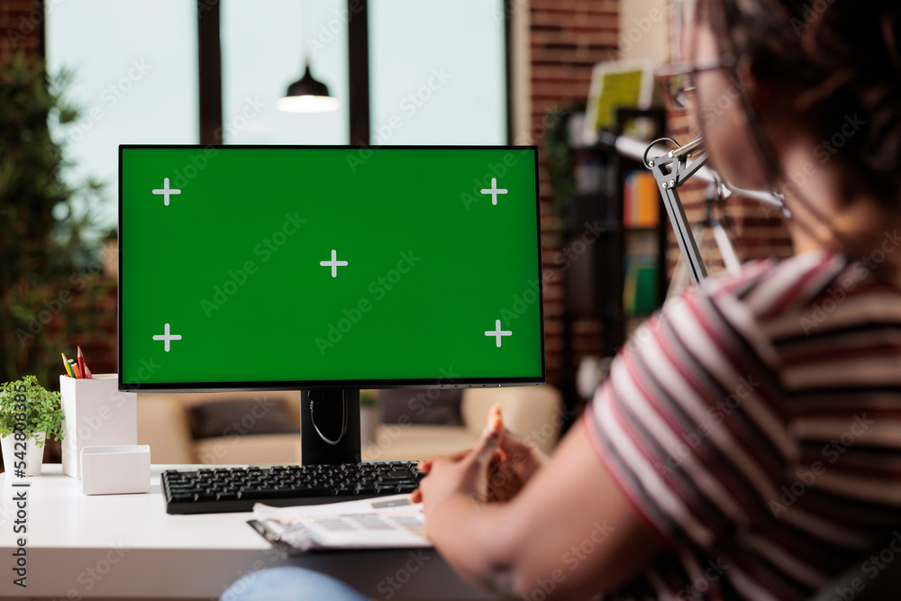 Remote worker computer with green screen at home office table, focus on ...