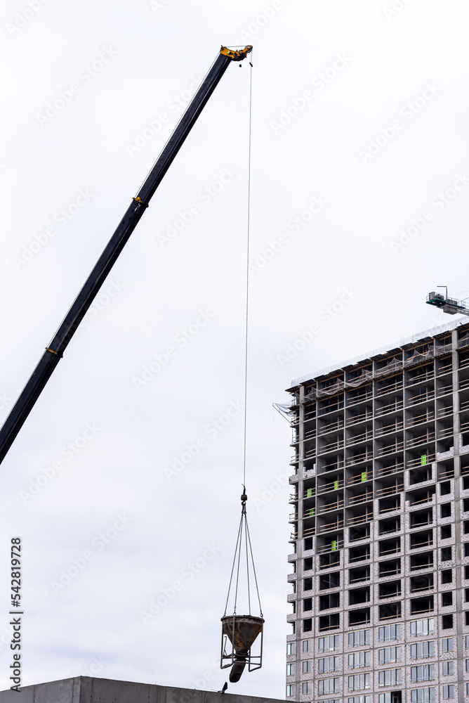 Crane tower at the construction site of a multi-storey residential ...