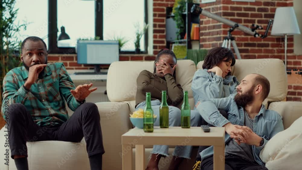 Diverse people getting scared watching horror thriller film, having ...