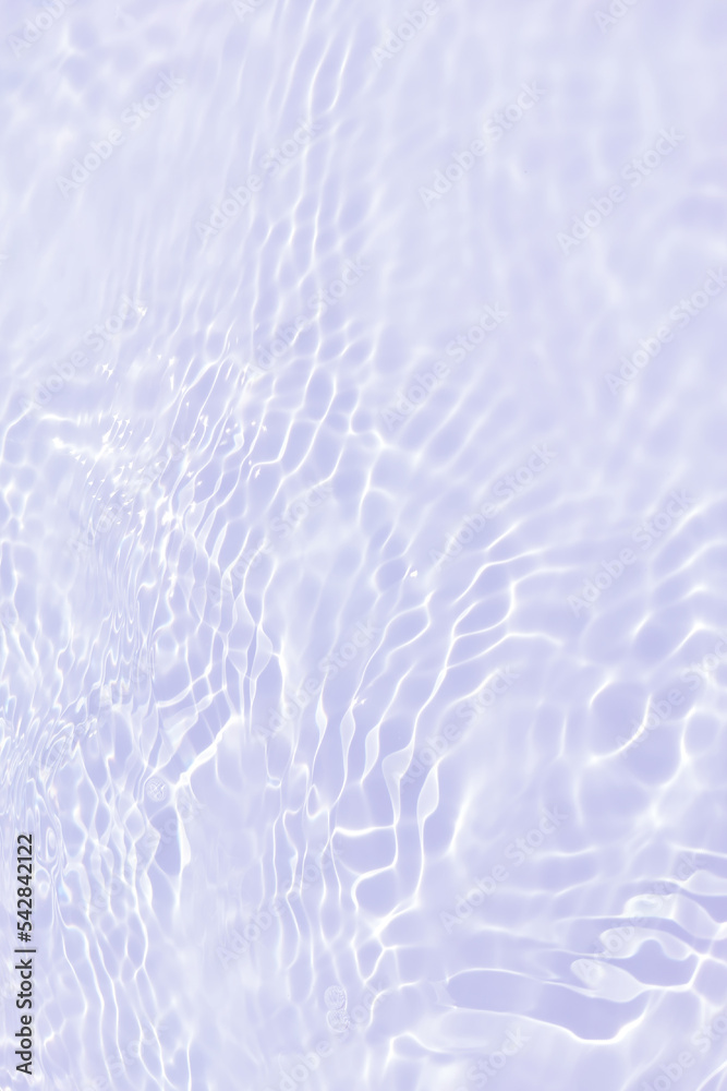 Defocus blurred transparent purple colored clear calm water surface ...