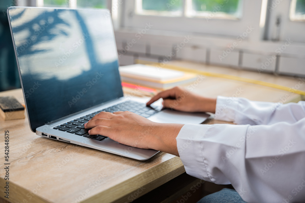 Back to school. Close up hands of female using computer sitting at ...