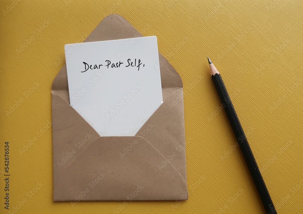 On yellow background, white card in craft envelope with handwriting ...