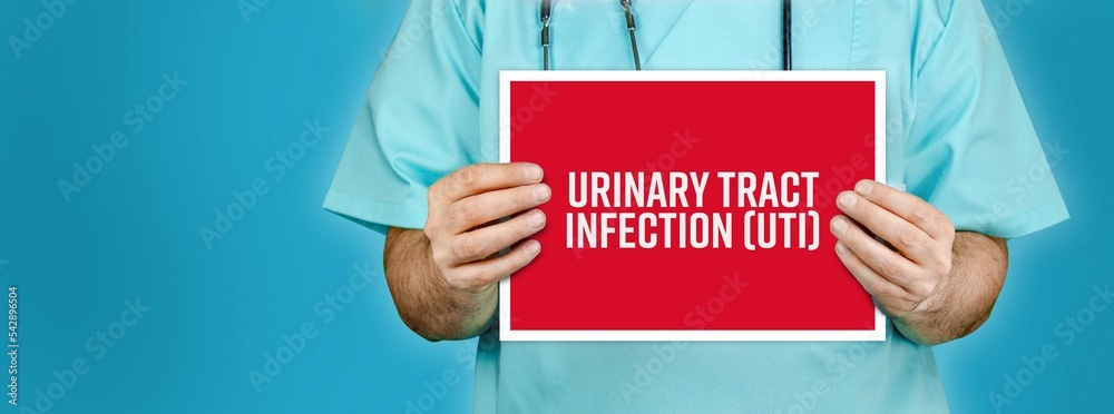 Urinary tract infection (UTI). Doctor shows red sign with medical word ...