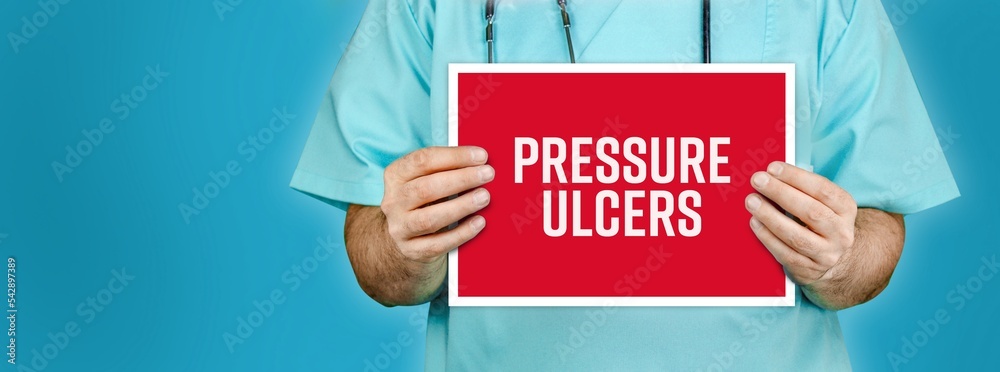 Pressure ulcers (bedsores). Doctor shows red sign with medical word on ...