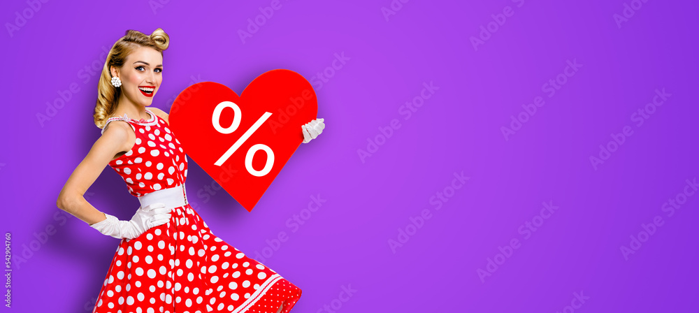 Woman holding red paper heart shape with % sign. Portrait image of ...
