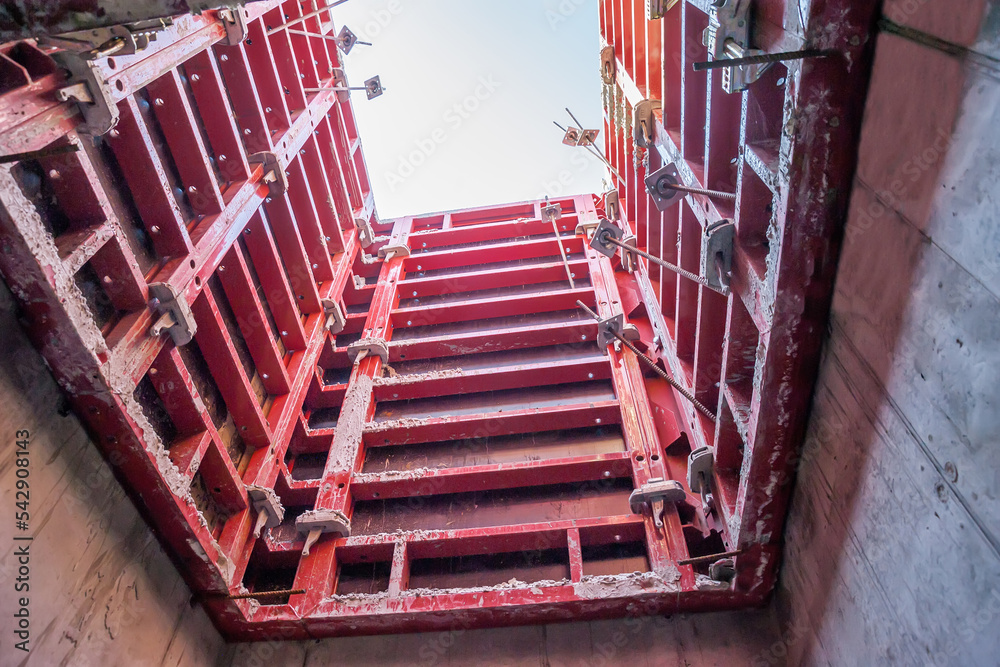Formwork panels connected by clamps at the construction of an elevator ...