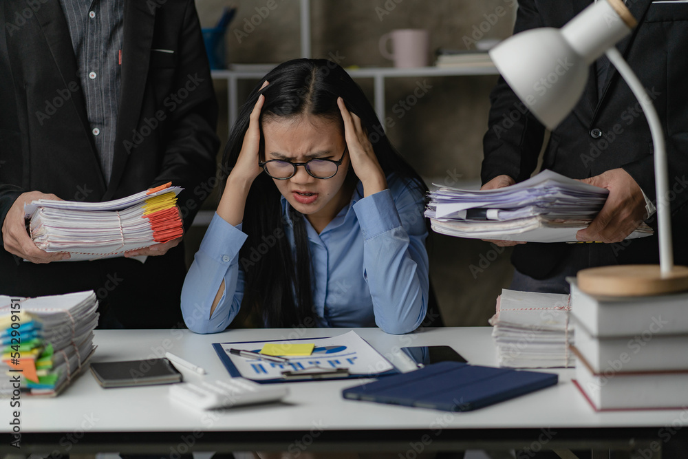 Asian female worker working overtime in the office late at night The ...