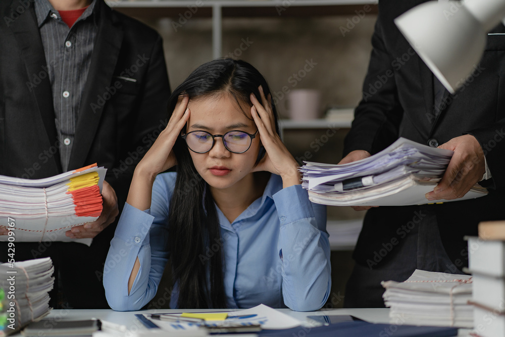 Asian female worker working overtime in the office late at night The ...