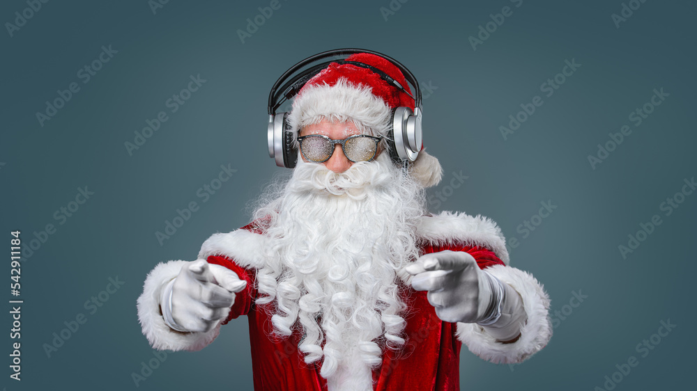 Cool Santa Claus is listening music in headphones Stock Photo | Adobe Stock