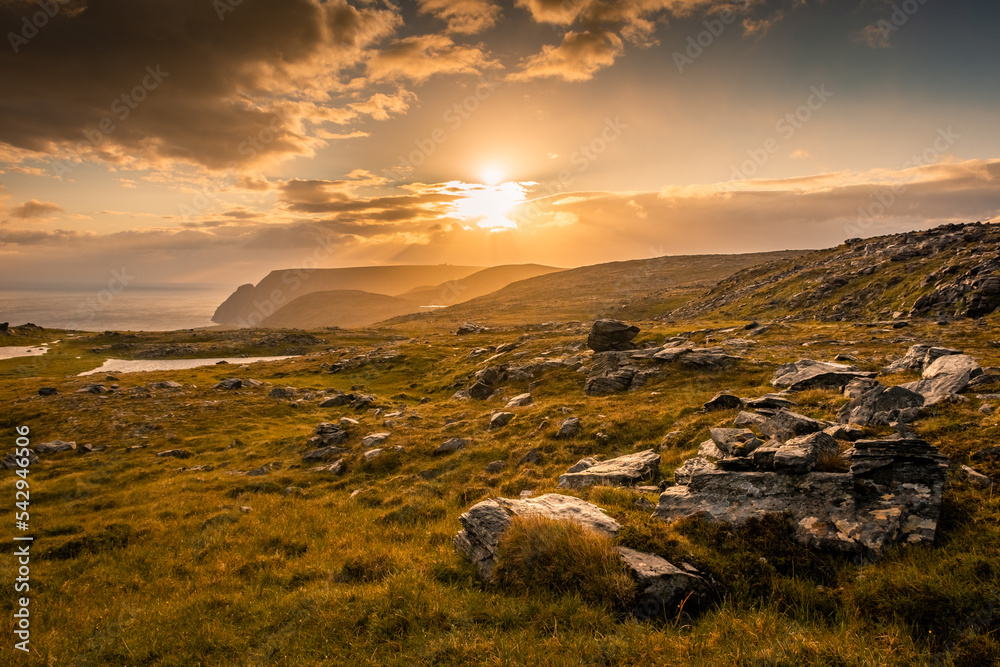 Midnight sun rising over Knivskjellodden, a trail in the tundra towards ...