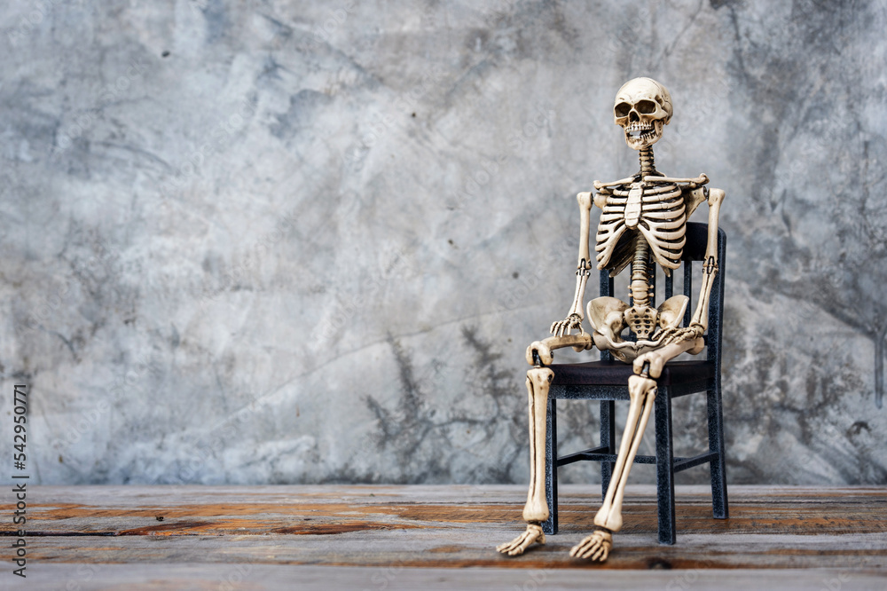 Concept of long waiting symbol. Human Skeleton sitting on a old chair ...