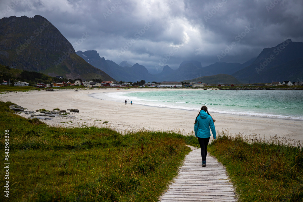 beautiful long-haired girl walks along the famous ramberg beach ...