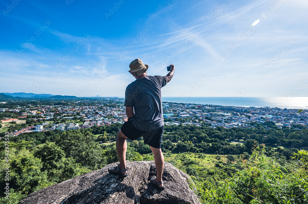 Asian fat man stand on the rock and take photo at Khao hin lek fai view ...
