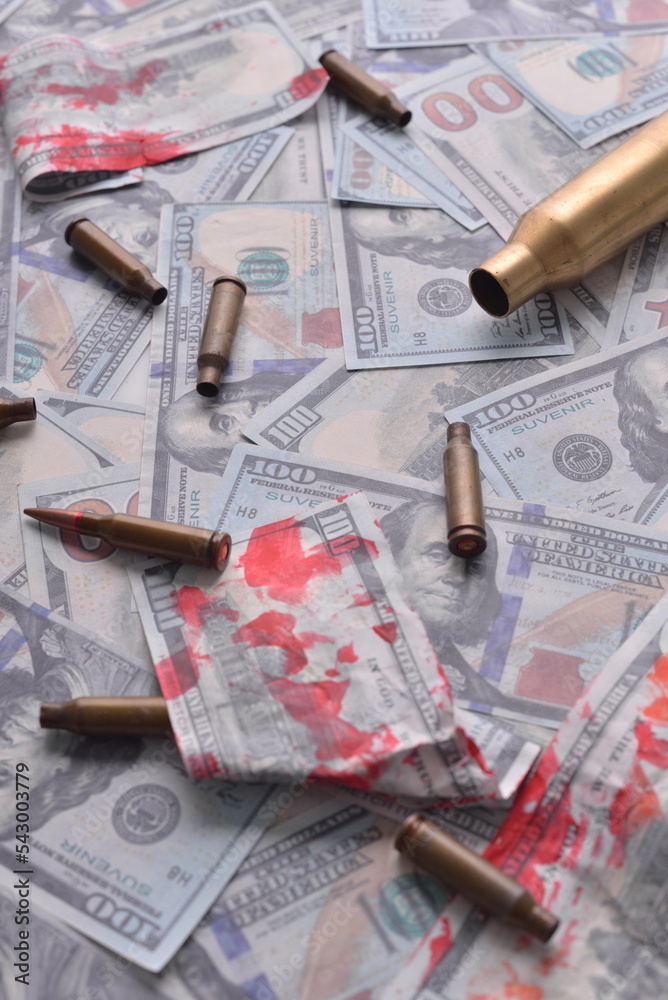 blood money of war. Cartridges with blood in dollar bills Stock Photo ...