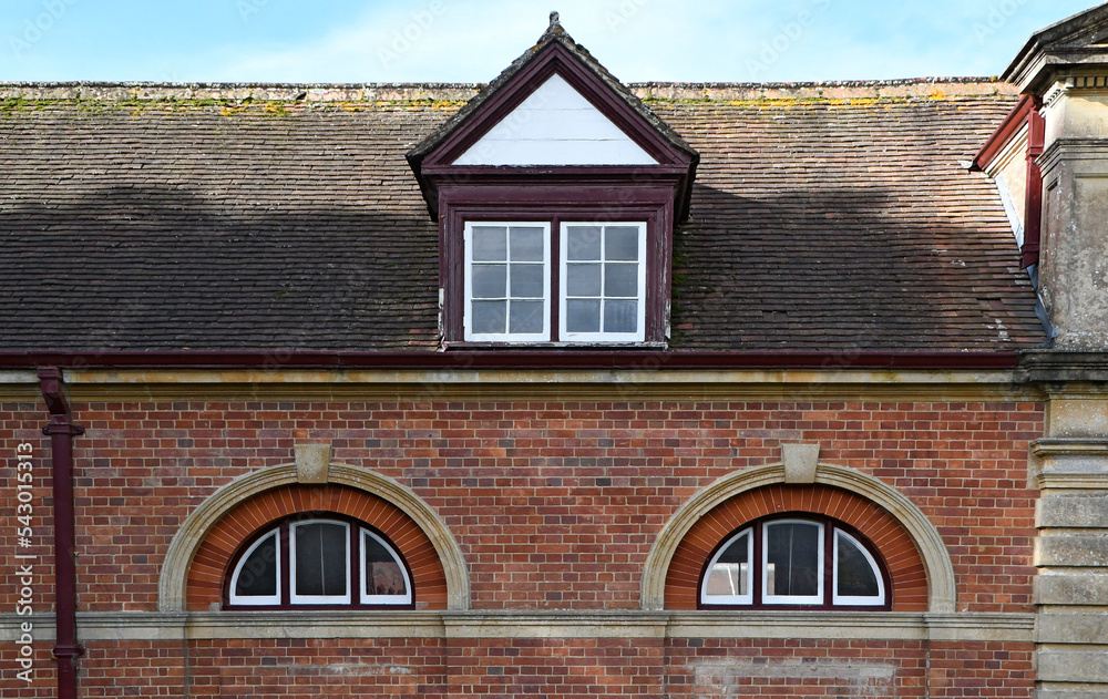 Arched and dormer windows in an old tiled roof Stock Photo | Adobe Stock