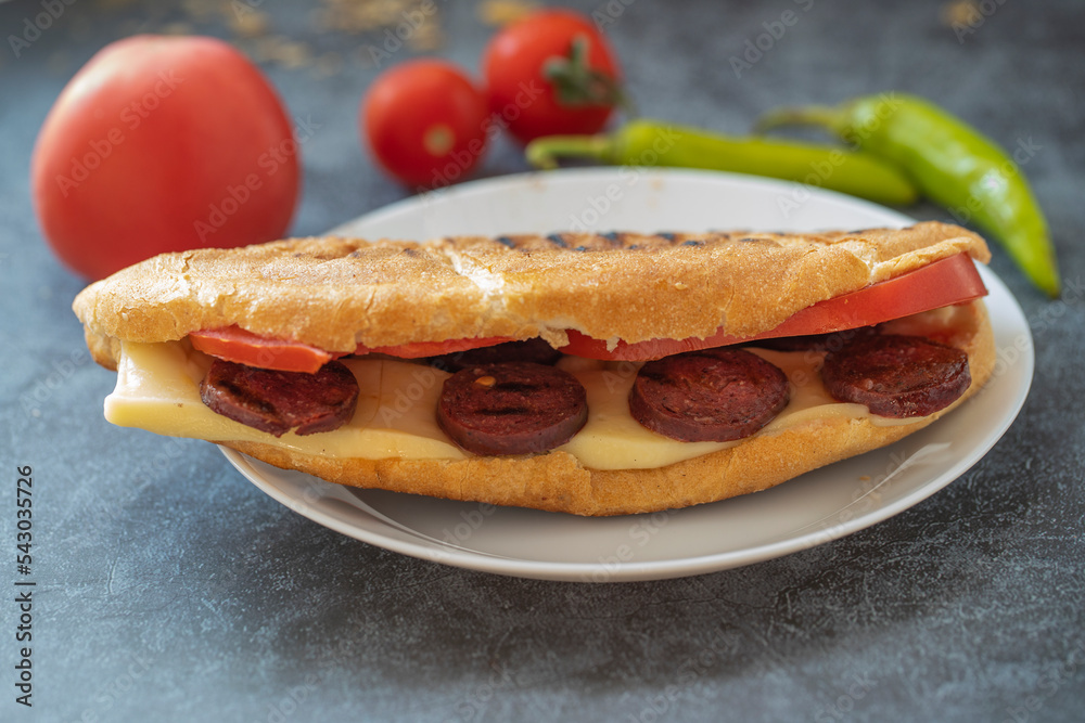 Turkish traditional toast sandwich, cheddar cheese, tomato, sausage ...