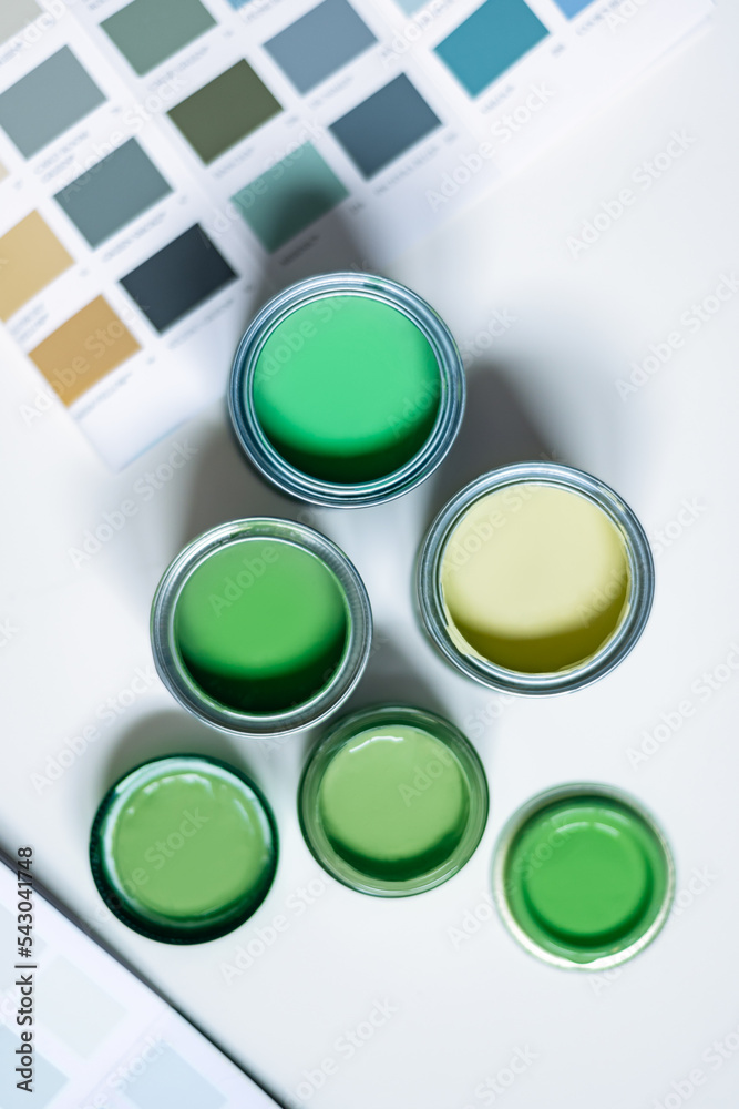Tiny sample paint cans during house renovation, process of choosing ...