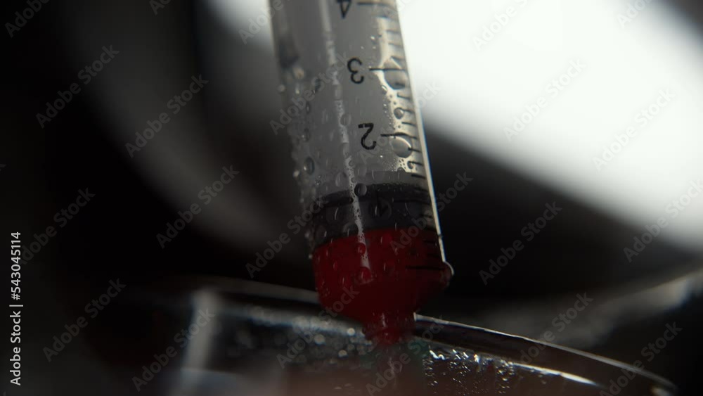 Syringe from which blood is drawn, taking medical blood sample ...