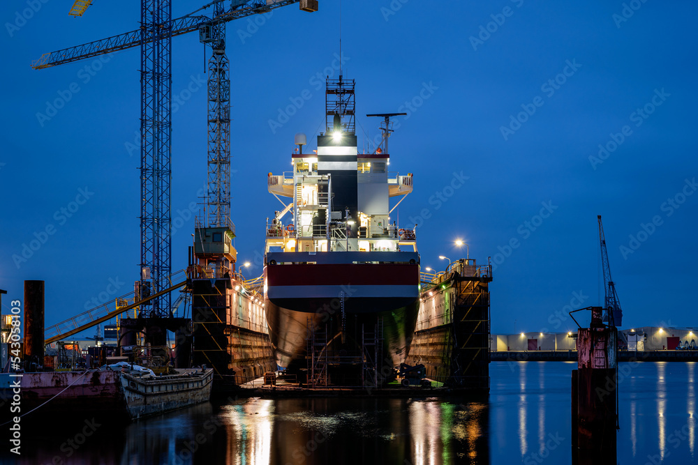 general cargo vessel in floating dock for maintenance at night Stock ...