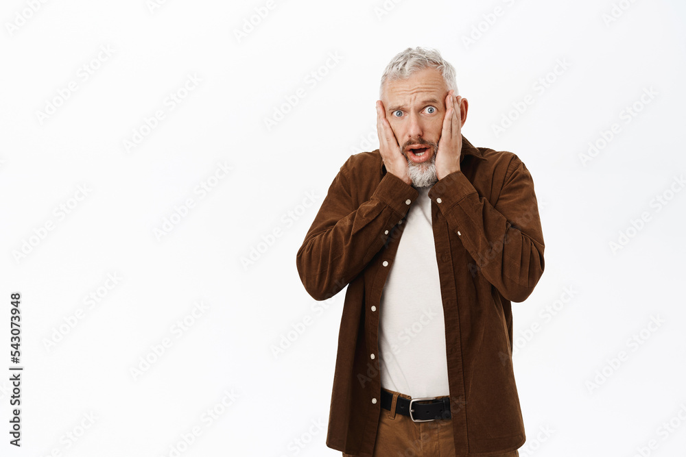 Shocked mature man, old male model looking speechless and stunned at ...