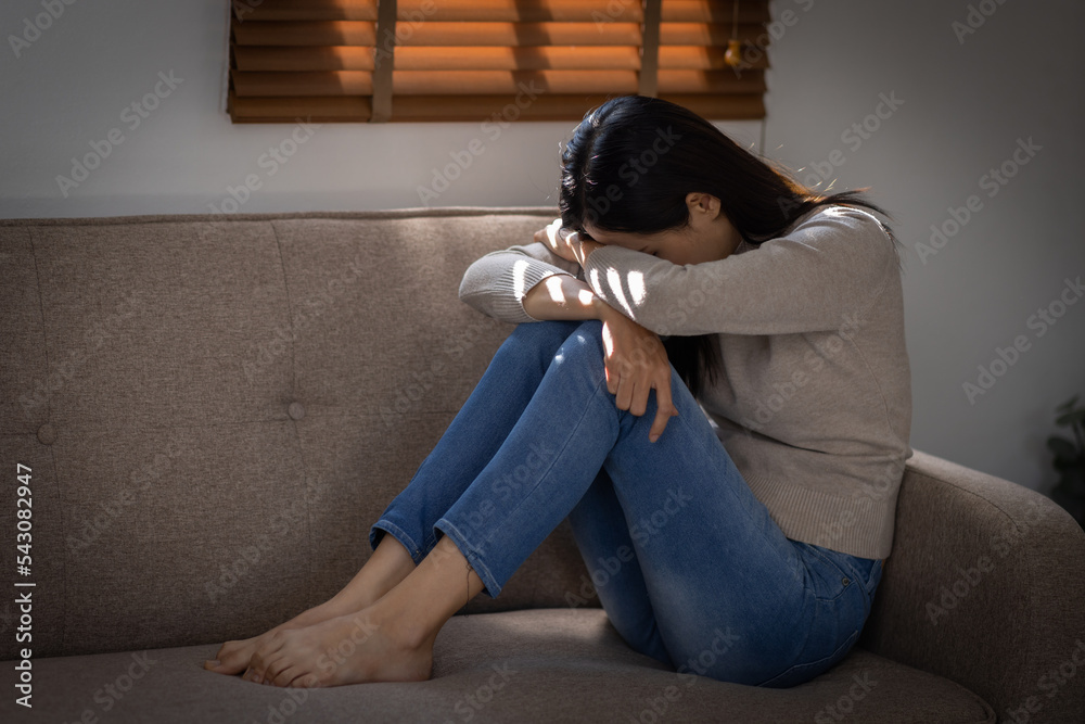 Sad Or Heart Broken Asian Woman Or Asian Girl Sitting On A Sofa In The