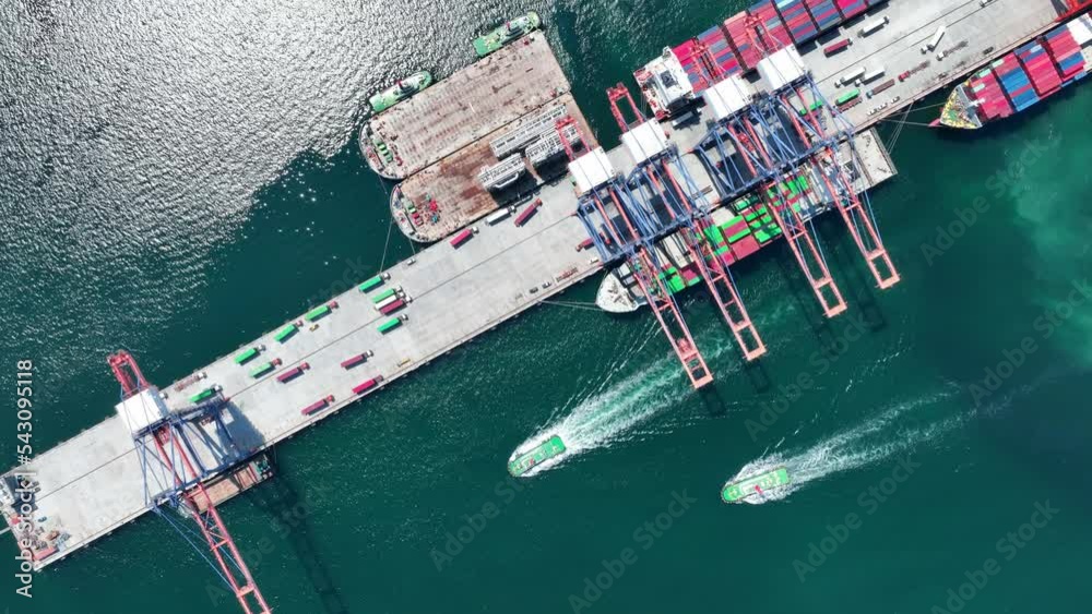 Cargo Container Ship Load Container Box under crane at bridge port ...