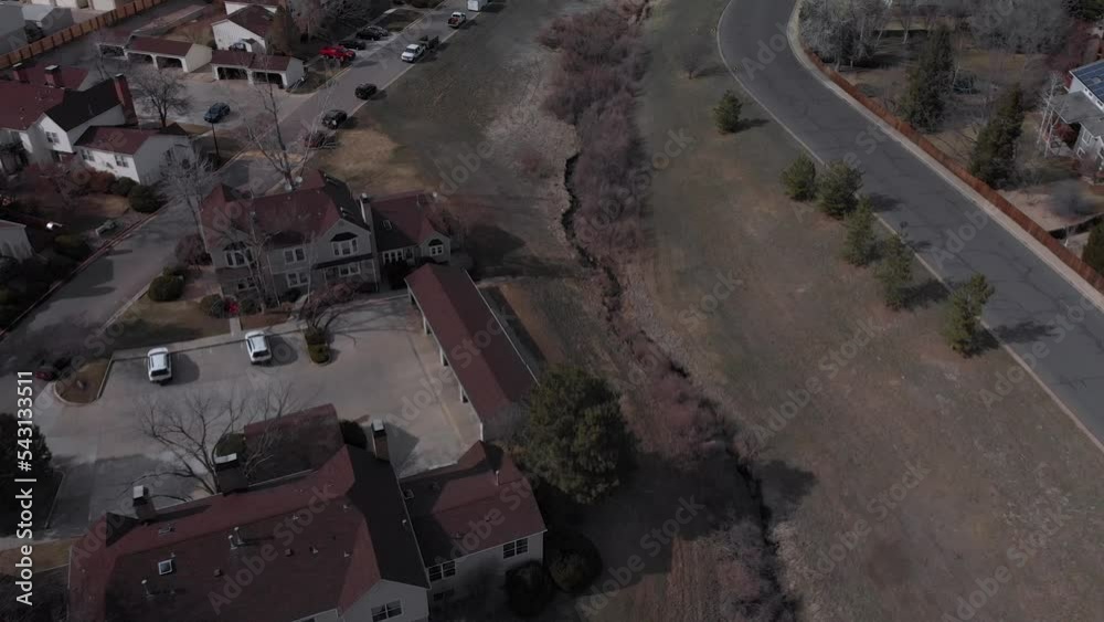 Stream Dividing Grassy Area Next to Townhouse Complex • Aerial Drone ...