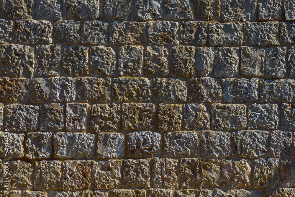 Old wall of natural stones. The ancient wall is made of rectangular ...