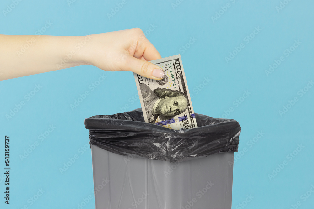 throw money into the bin, one hundred dollars in hands in front of the ...