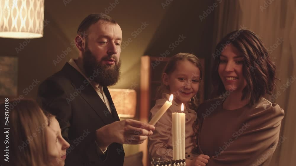 Happy Jewish married couple with three little daughters celebrating ...