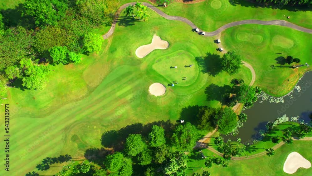 Aerial view over golf field landscape during sunrise. Hobby and sports ...