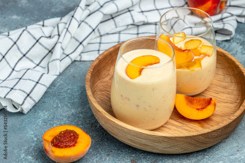 Peach drink in a glass with milk on a light background, Healthy eating ...