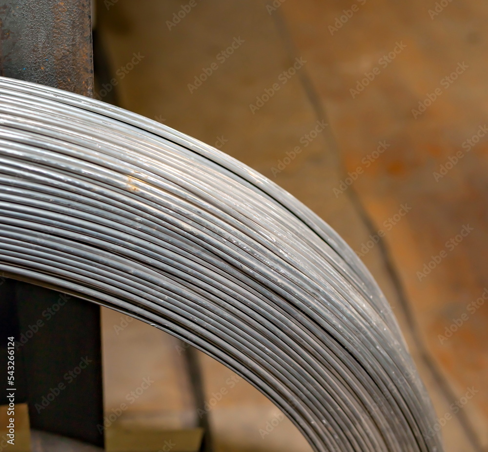 Part of the welding wire coil in close-up in the mechanical assembly ...
