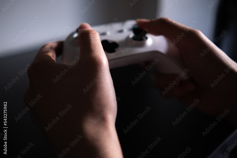 human hand holding console game controller photo in modern black ...
