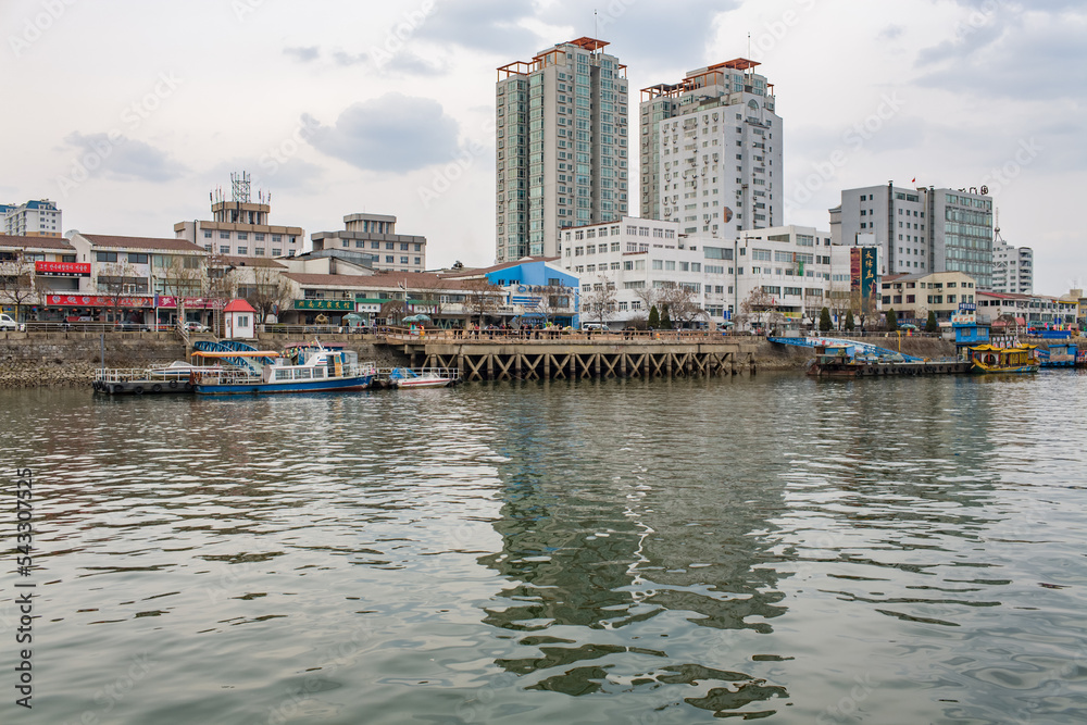 DANDONG, CHINA: the modern chinese city, seen from the Yalu river ...