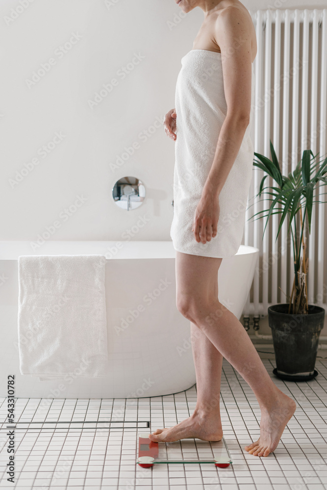 Woman stand on floor scales, checking weight in bathroom Stock Photo ...