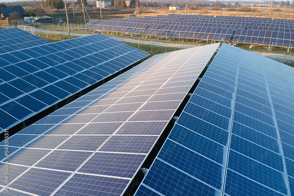Aerial view of large sustainable electrical power plant with rows of ...