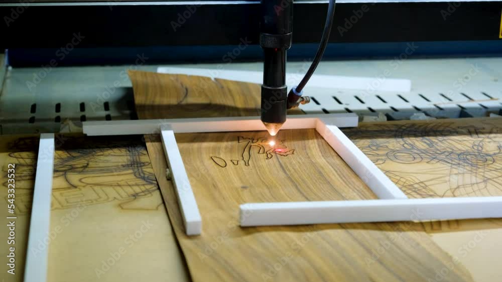 Laser cutting beam high precision on a plywood sheet. Modern technology ...