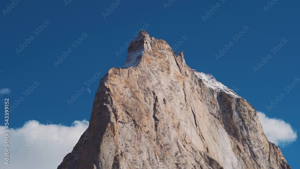 4K Closeup shot of peak of holy Gumbok Rangan mountain with moon ...