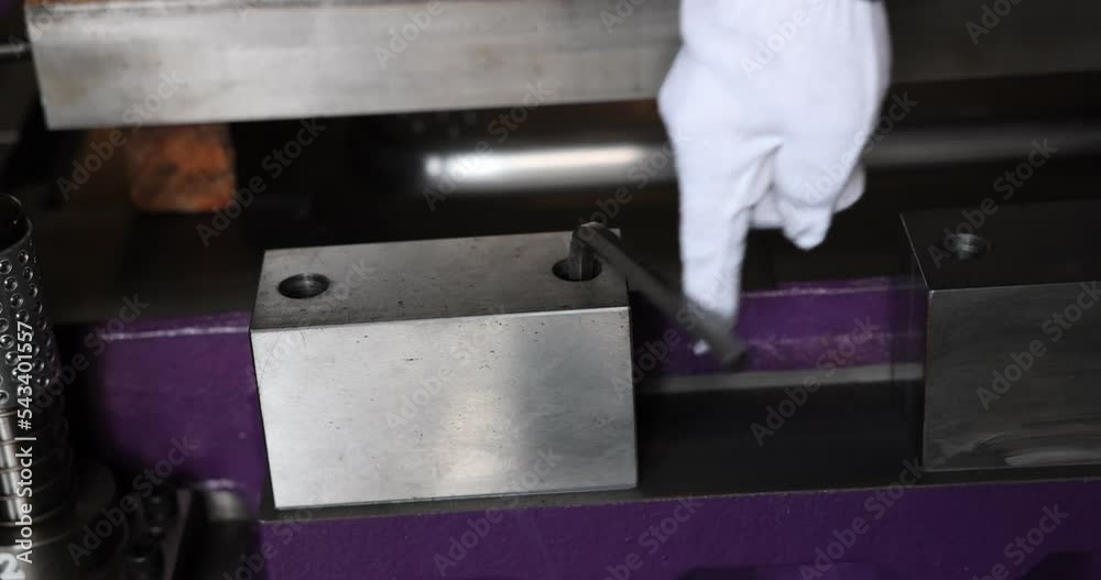 Parts of a press die being fastened with a hexagonal wrench. Stock ...