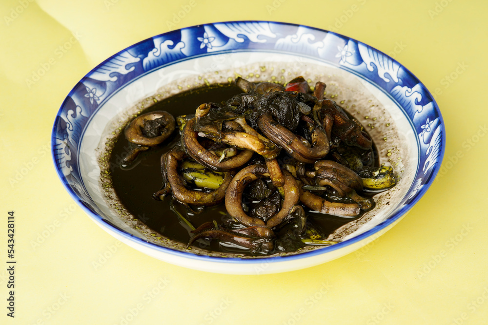 Squid Black Soup or Sauteed black squid is processed squid that is cooked until the squid ink is ...