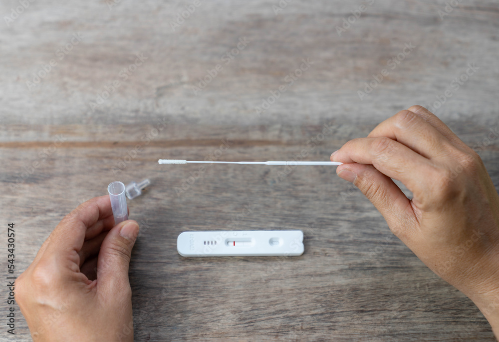 People using Covid-19 rapid self-test kit at home. Stock Photo | Adobe ...