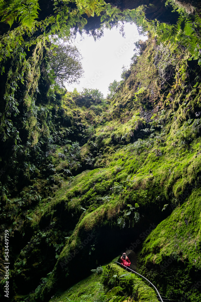Cave in azores island. Mysterious cave with female looking up. Mystery ...