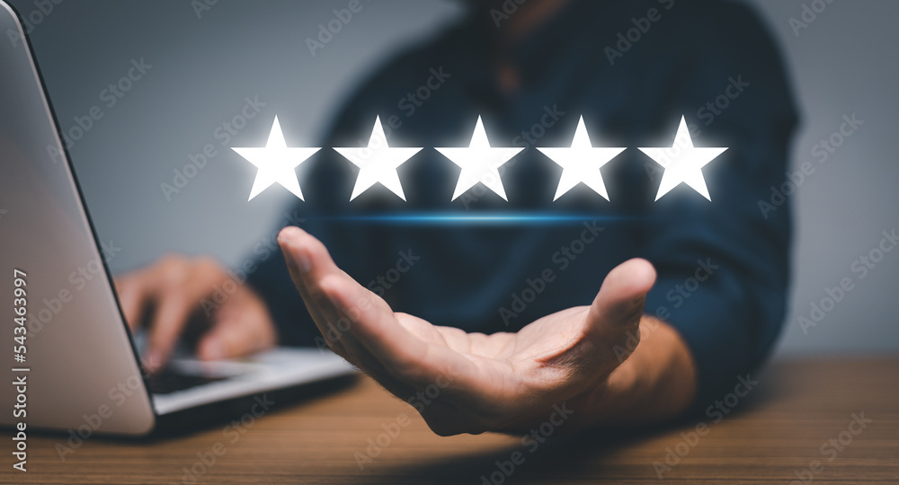 hand of customer or client holding the stars to complete five stars ...
