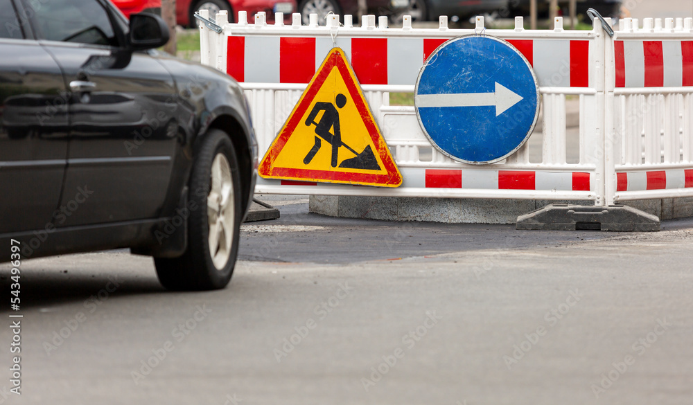 Sign on the road. Under construction board sign with arrow sign ...