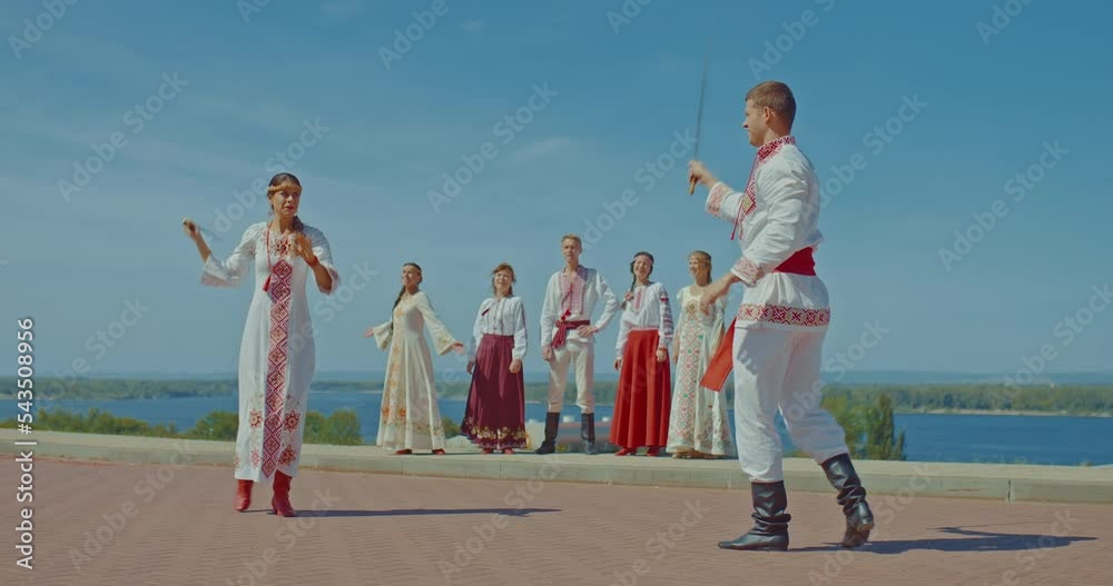 Male and female Slavs flank with sabers, stand in an embrace and ...