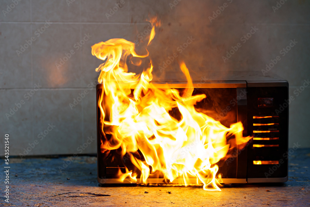 microwave oven on fire. the concept of fire in the kitchen and ...