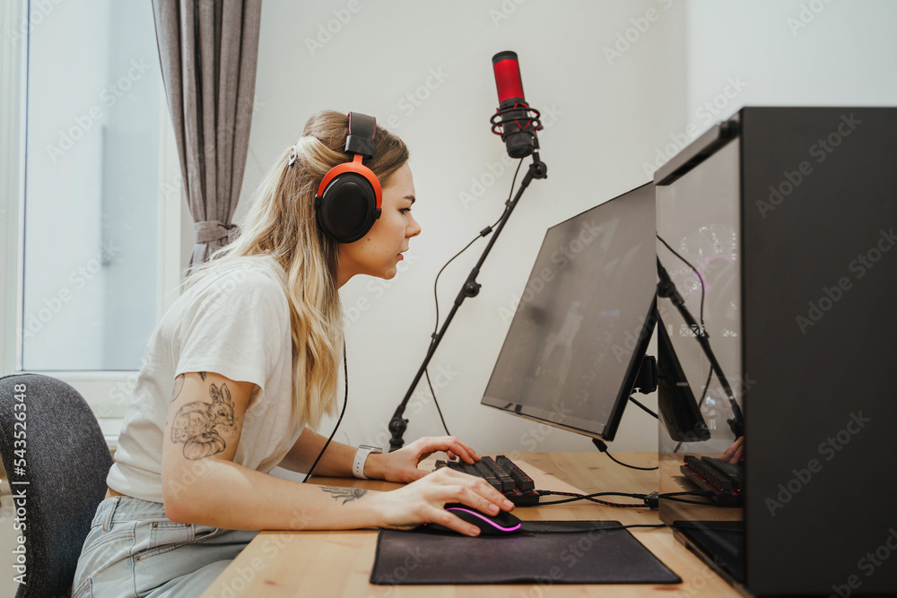 Girl professional esports athlete playing video game on her modern ...