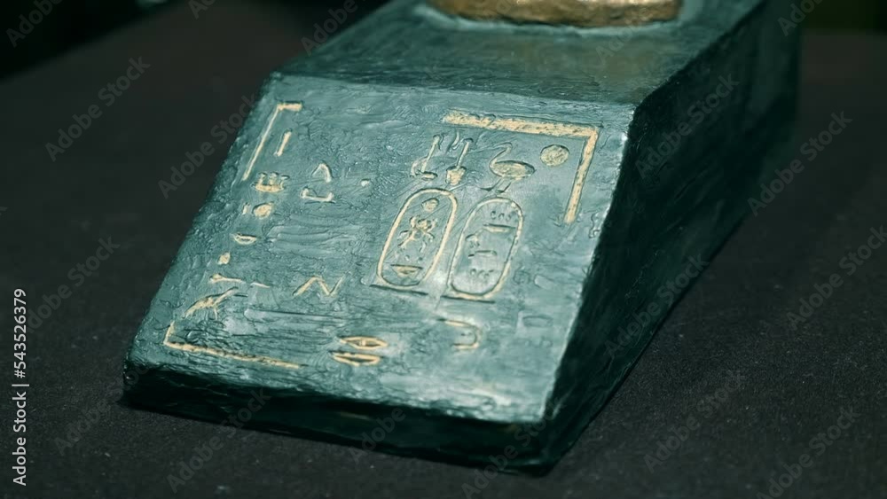 The base of the figurine is covered with hieroglyphs, signs, symbols ...